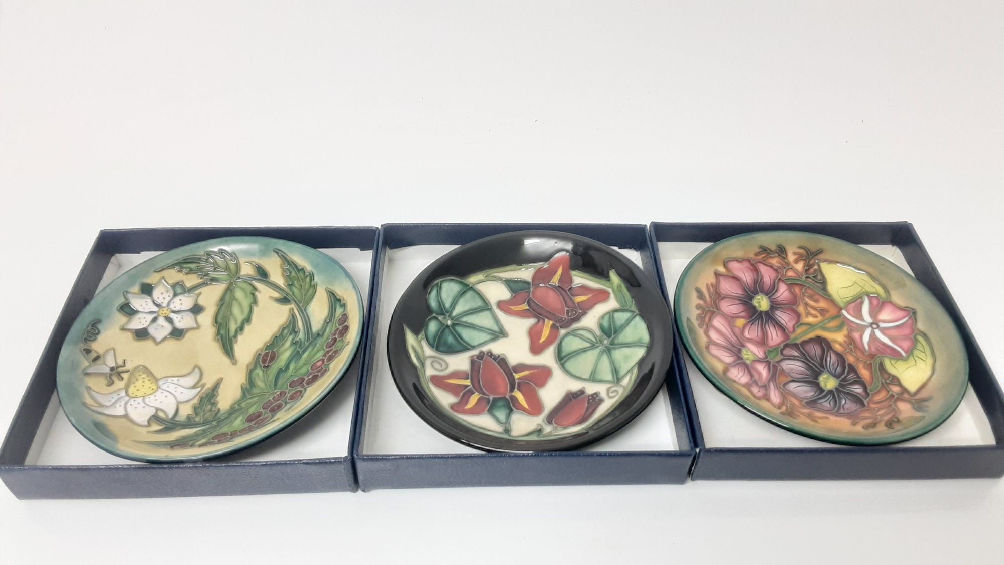 Lot 1106 - Set of eleven Moorcroft pin dishes, various