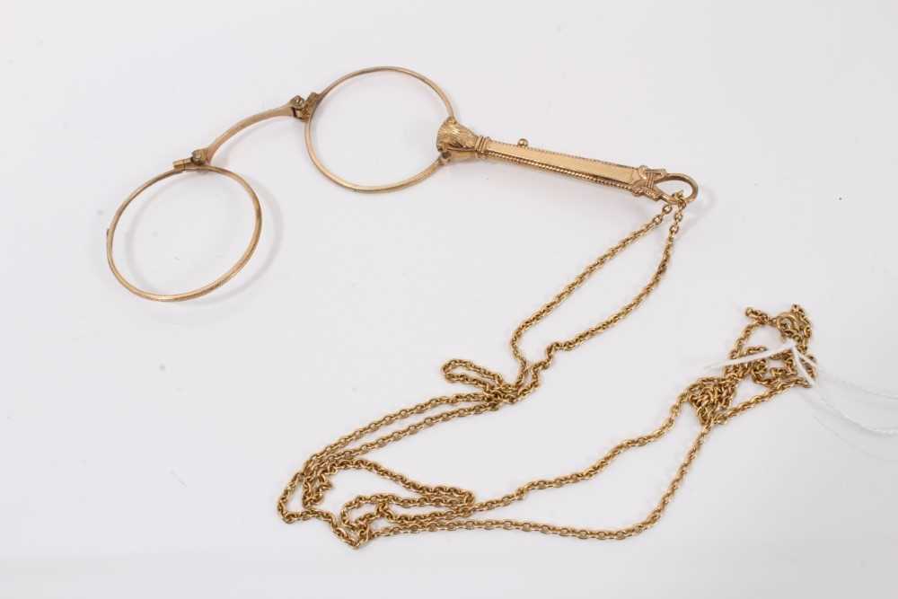 Lot 720 - Antique gilt metal lorgnette on a yellow