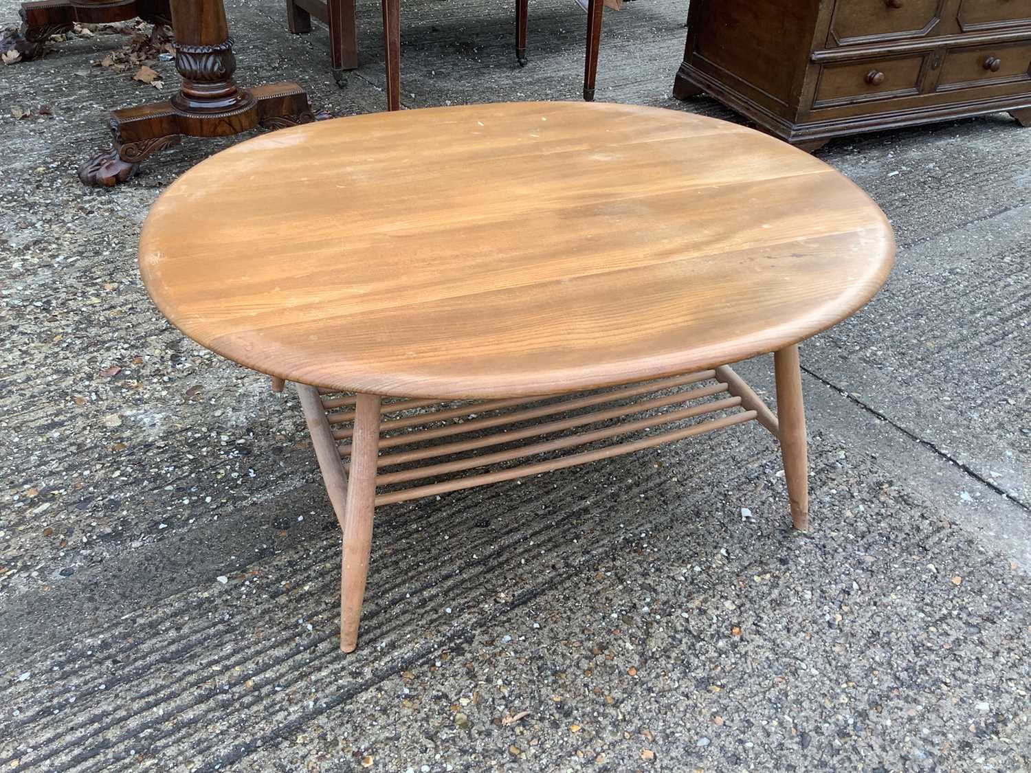 Lot 1109 - Ercol oval coffee table with magazine rack