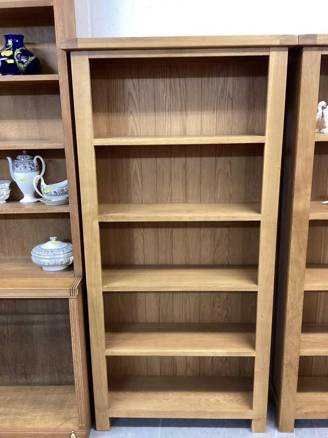 Lot 1069 - Pair of light oak open bookcases