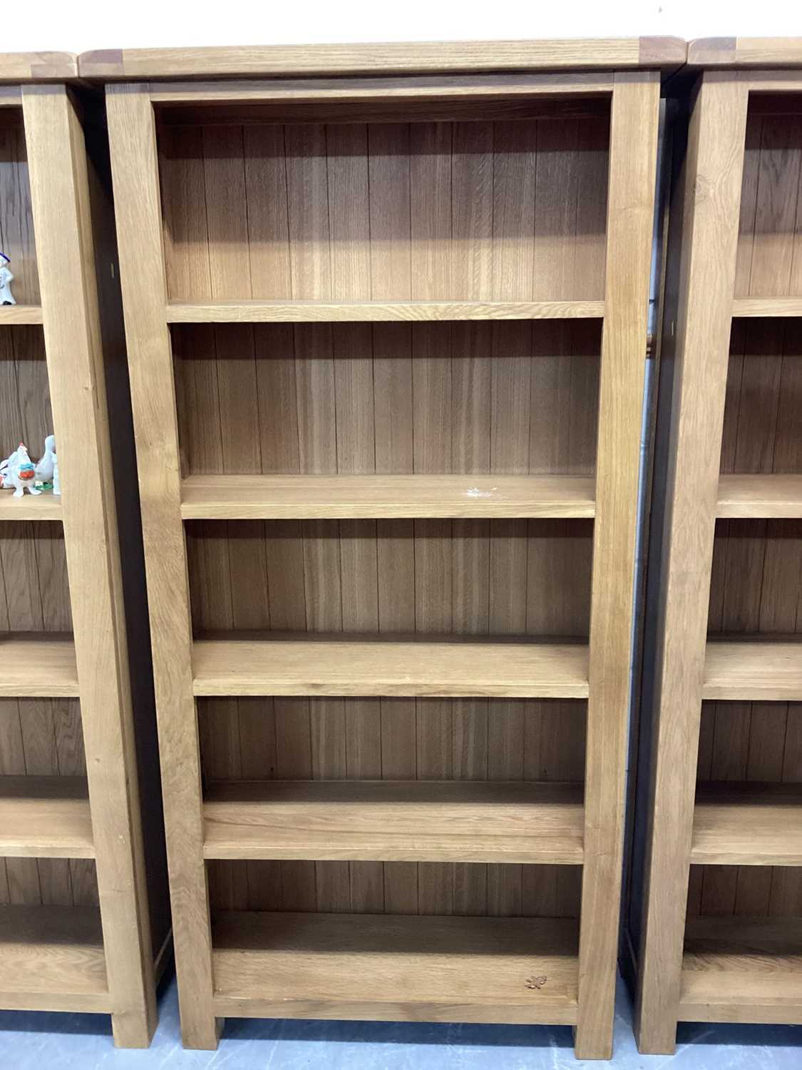 Lot 1070 - Pair of light oak open bookcases