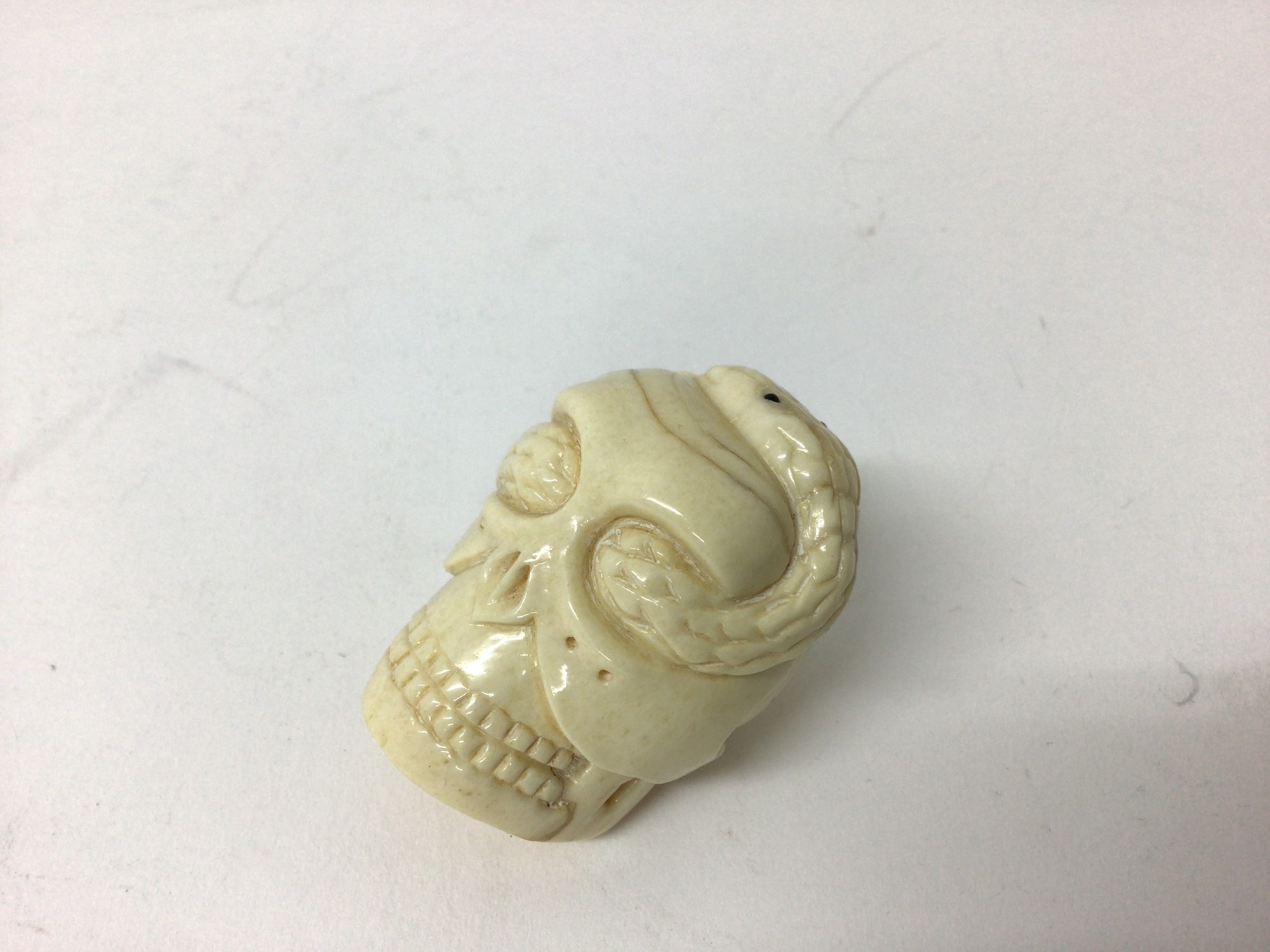 Lot 99 - Japanese ivory netsuke, carved in the form of