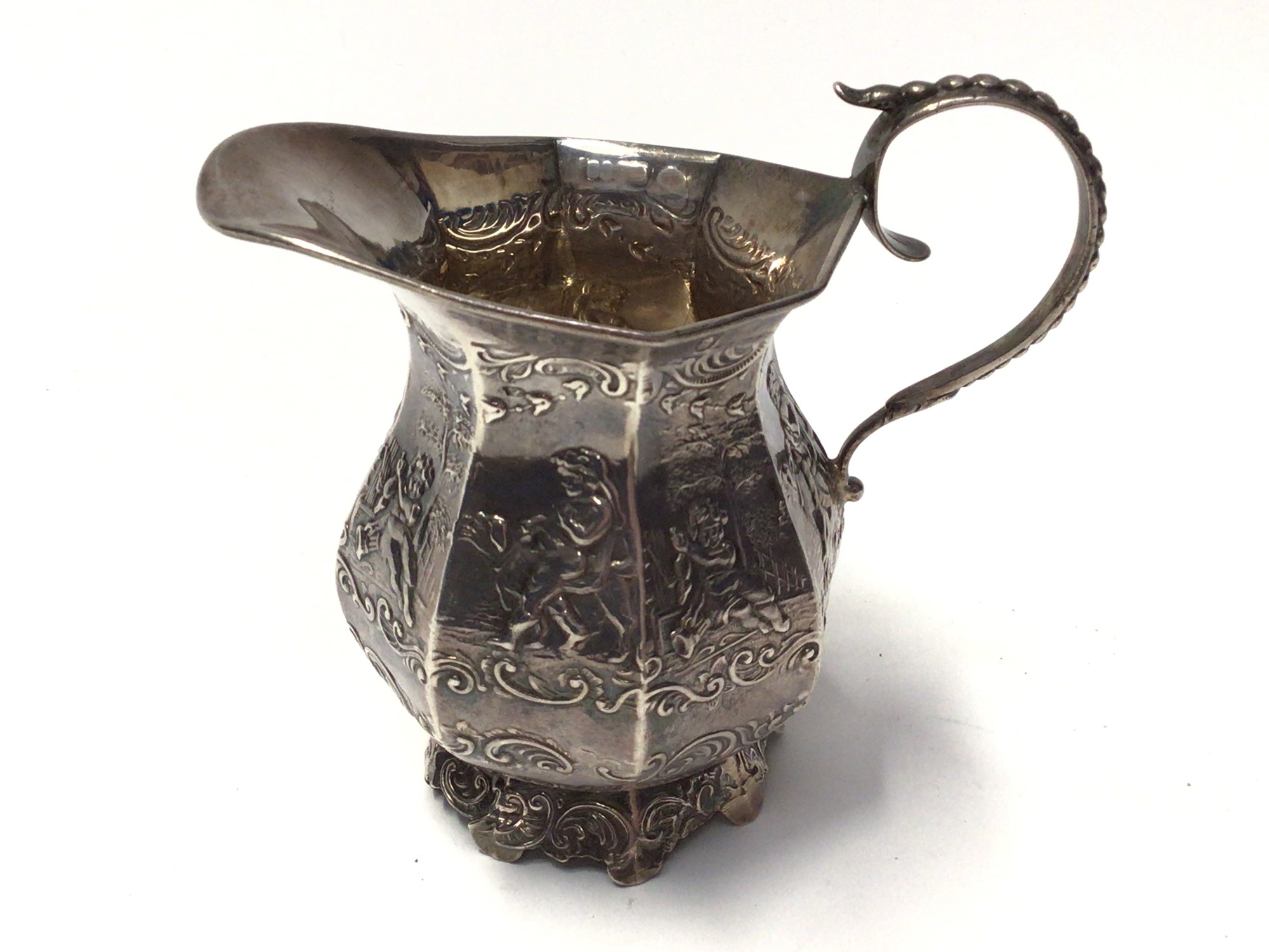 Lot 133 - Dutch silver cream jug with embossed figure