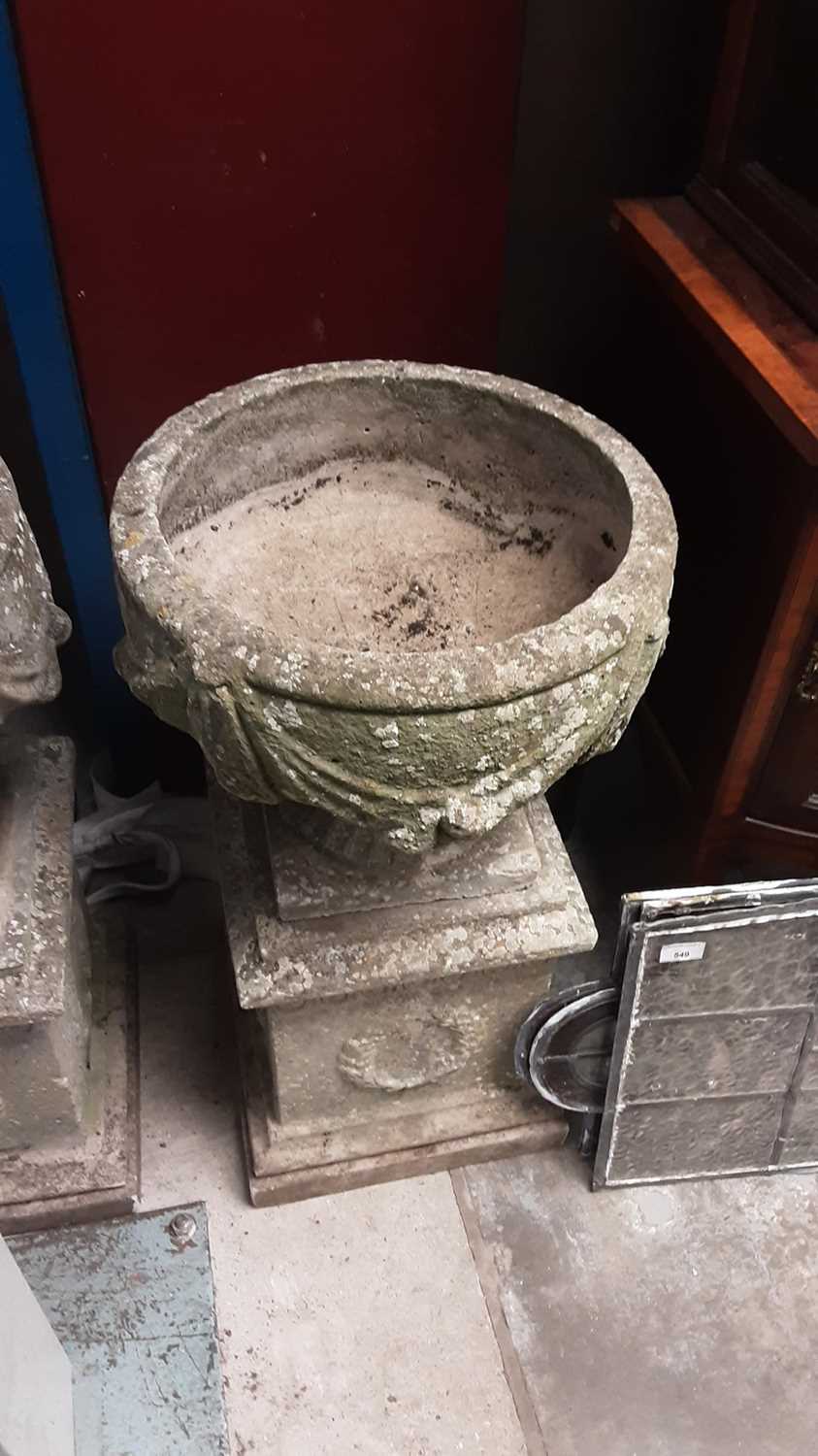 Lot 1338 - Pair of concrete garden urns on plinth