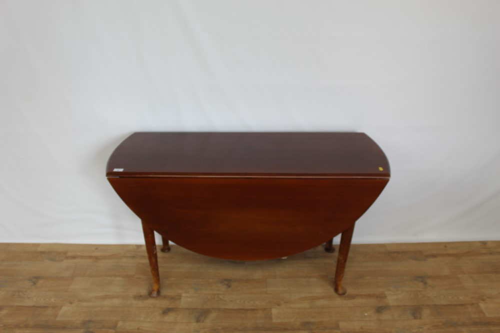 Lot 50 - Mahogany oval drop leaf table on turned legs,