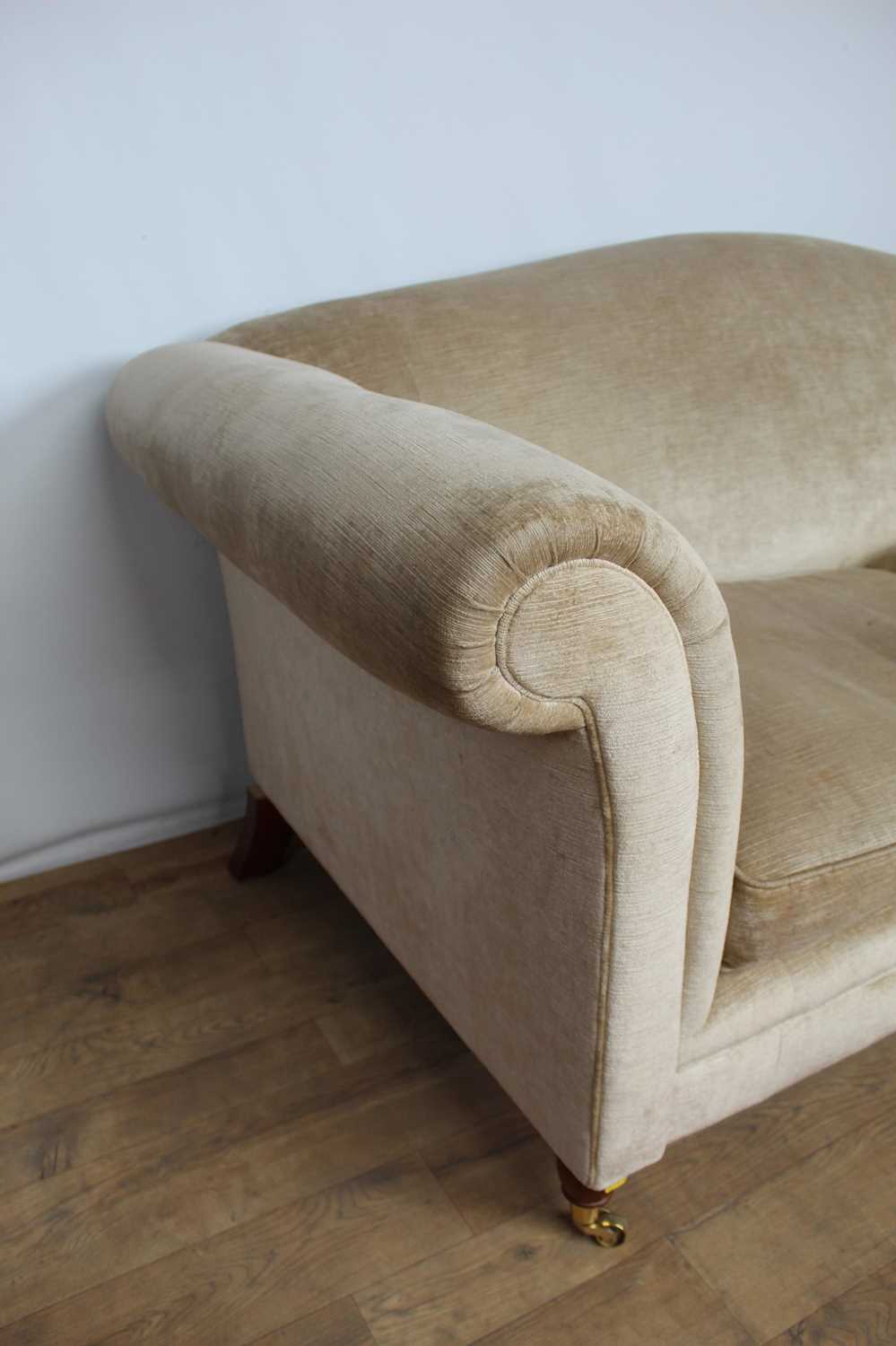 Lot 161 - Contemporary camel back sofa on brass