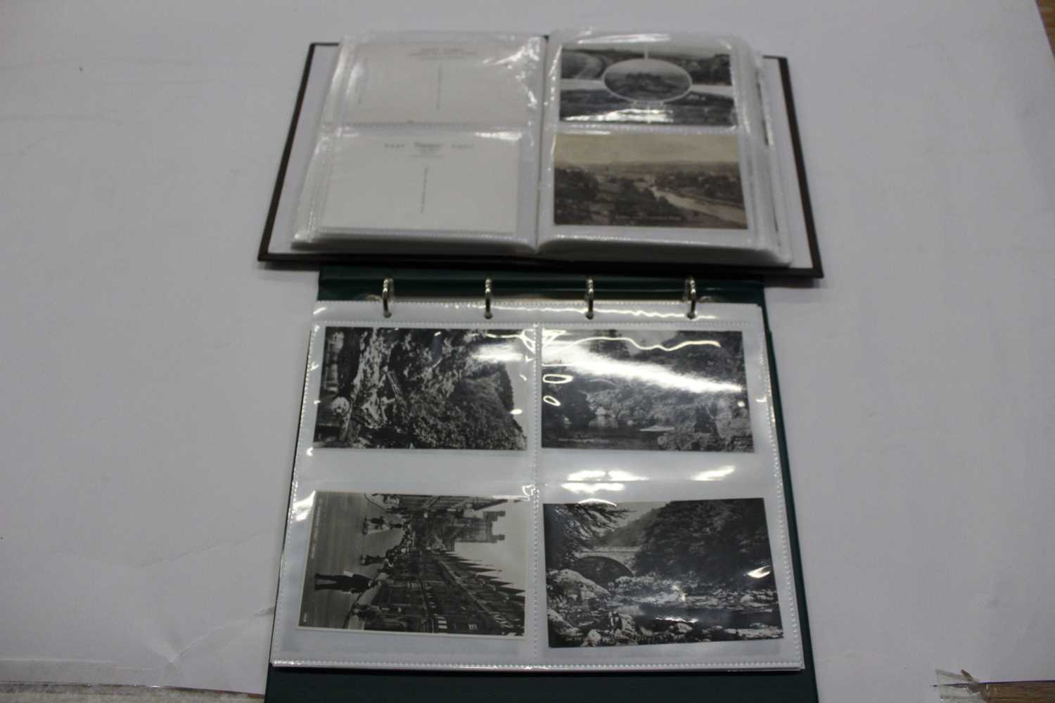 Lot 1499 - Large box of postcards in three albums and