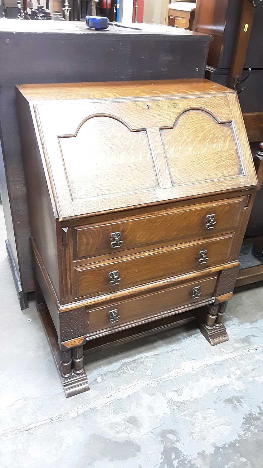 Lot 1058 - 1930's oak bureau with three drawers, 75cm