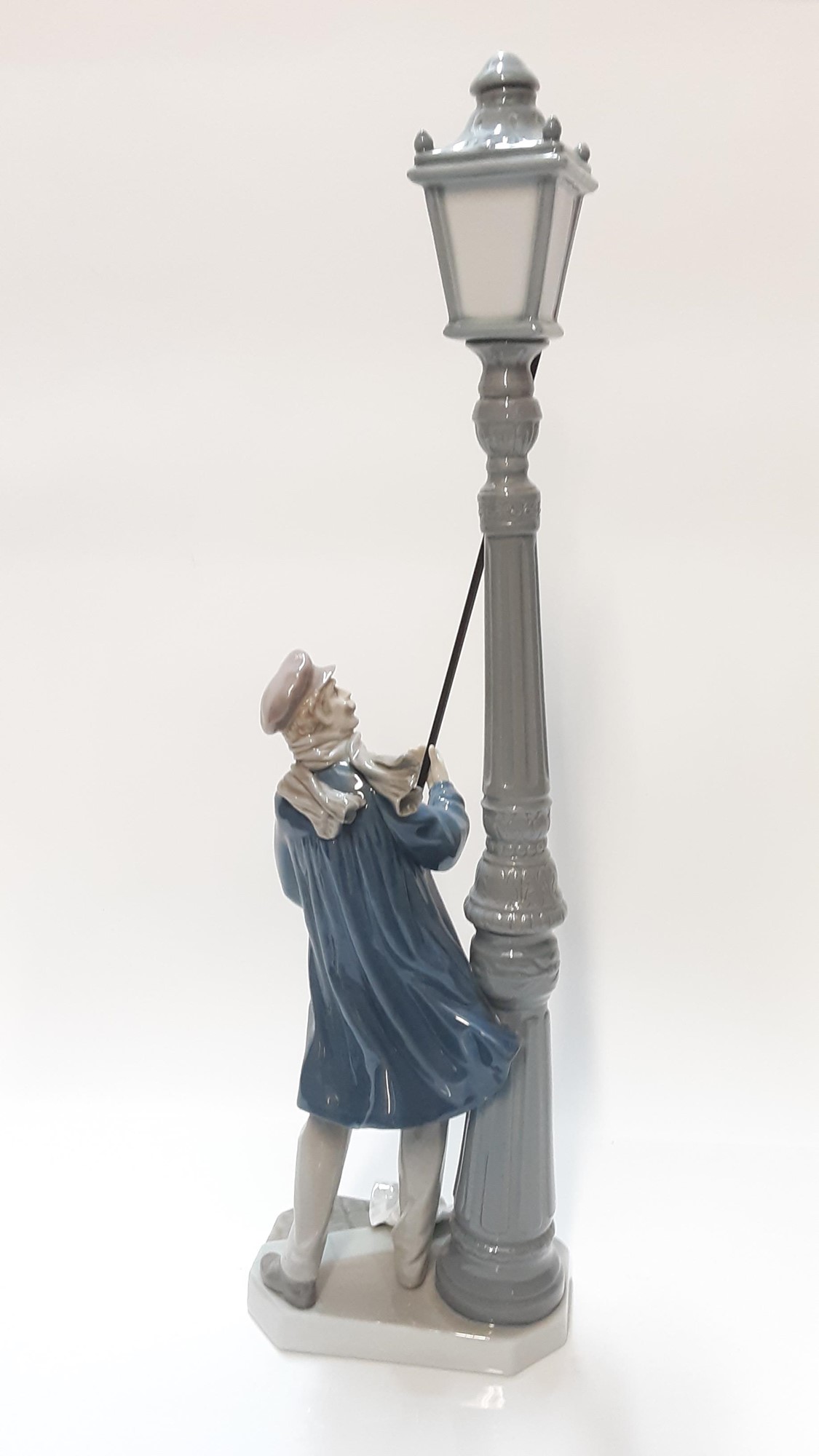 Lot 1182 - Lladro porcelain figure of a man lighting