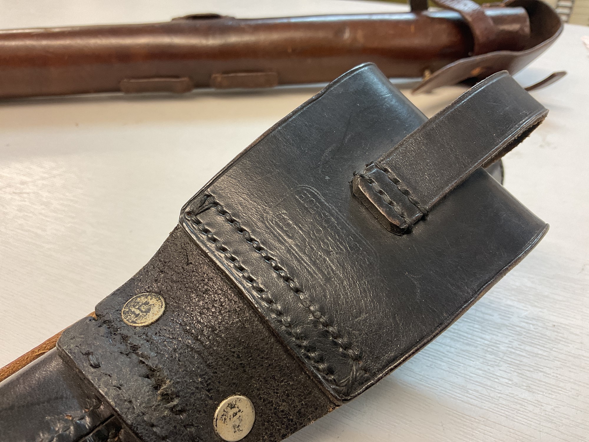 Lot 620 - Two mounted Police batons in leather sheaths