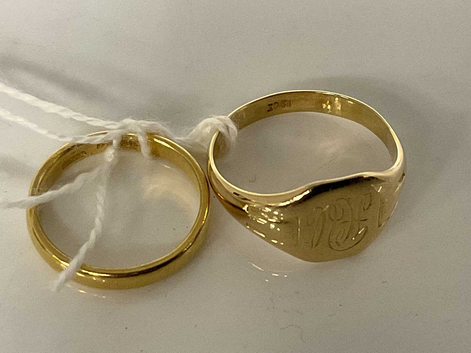 Lot 1100 - 22ct gold wedding band together with an