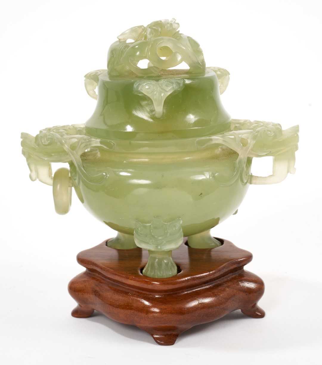 Lot 656 - Chinese carved green jade pot and cover on a