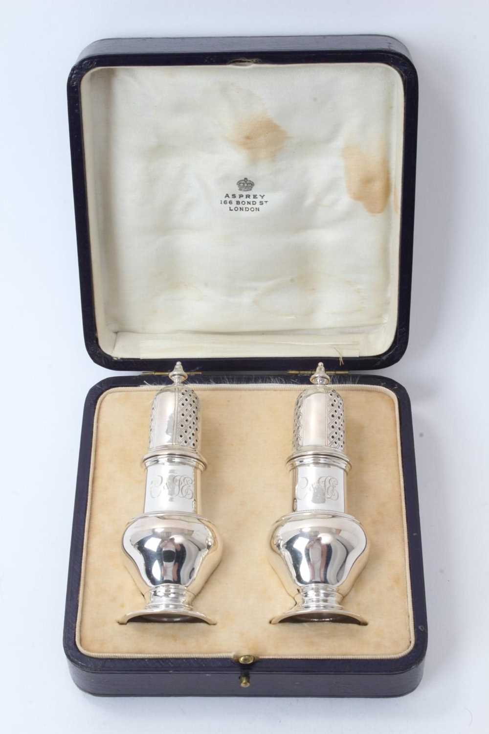 Lot 186 - Pair of Asprey silver pepperettes in fitted