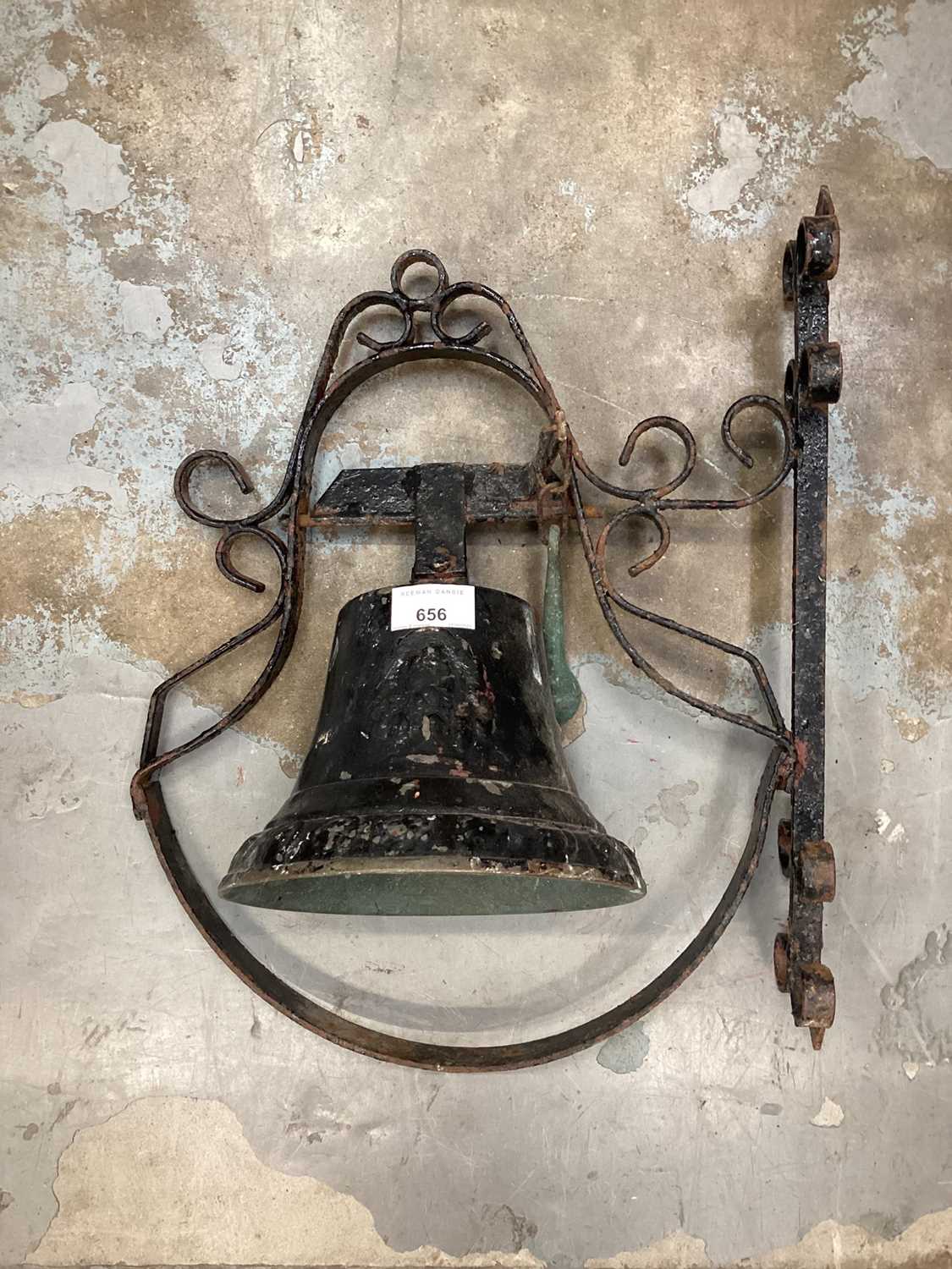 Lot 656 - Large bell on black painted wrought iron