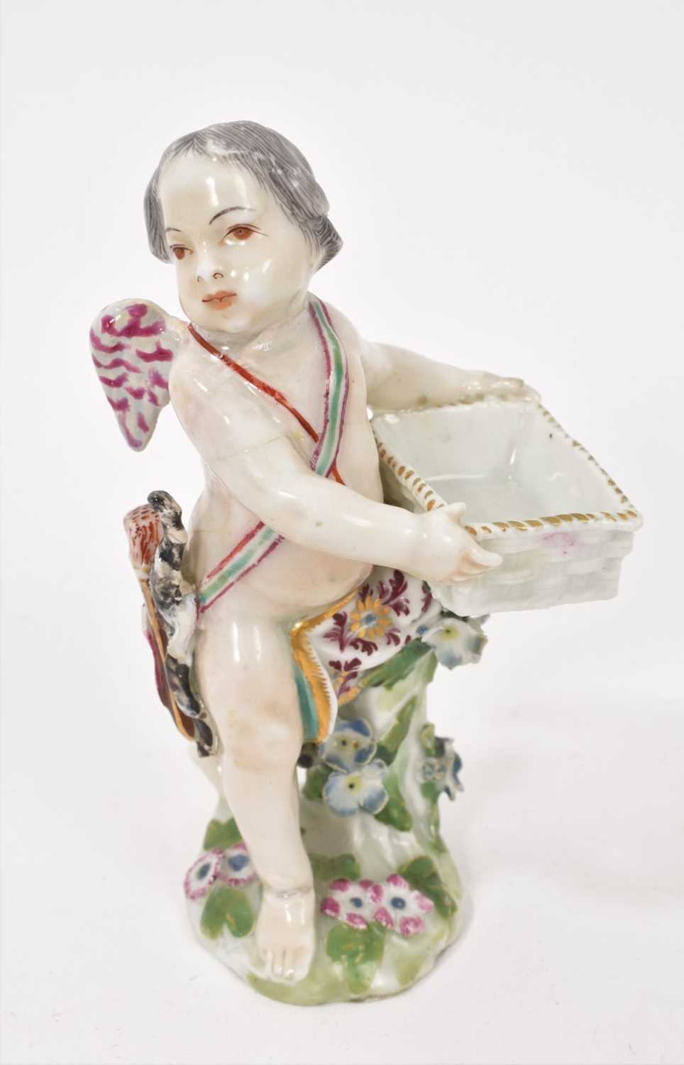 Lot 236 - Chelsea figure of Cupid, holding a
