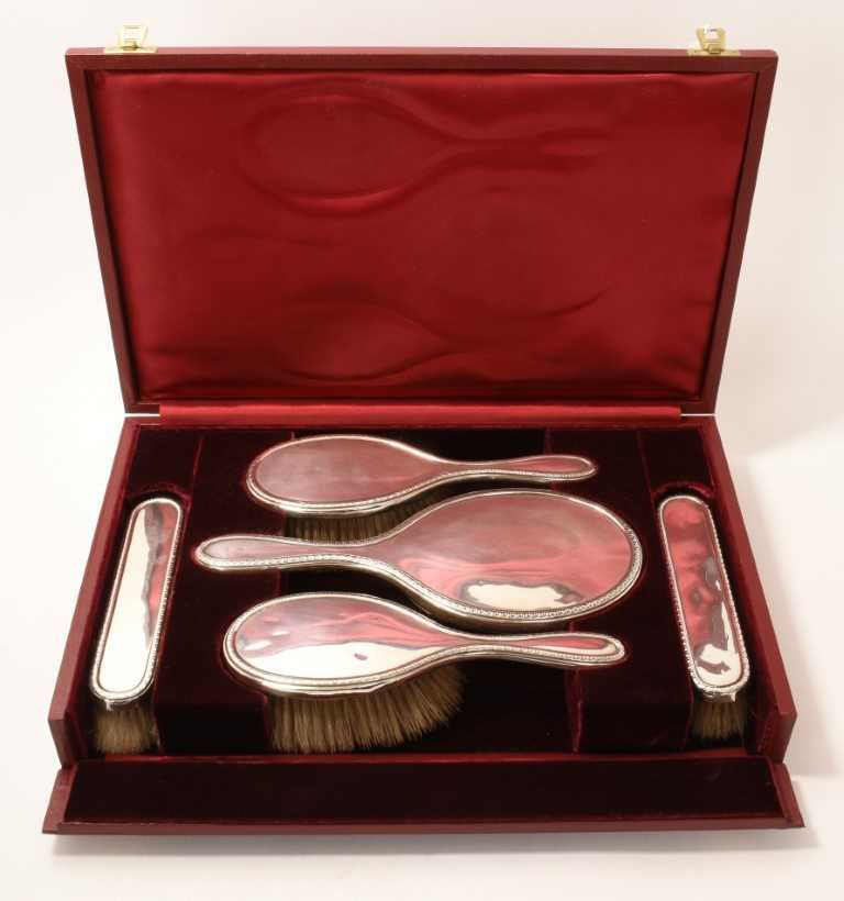 Lot 223 - Silver dressing table set in fitted red