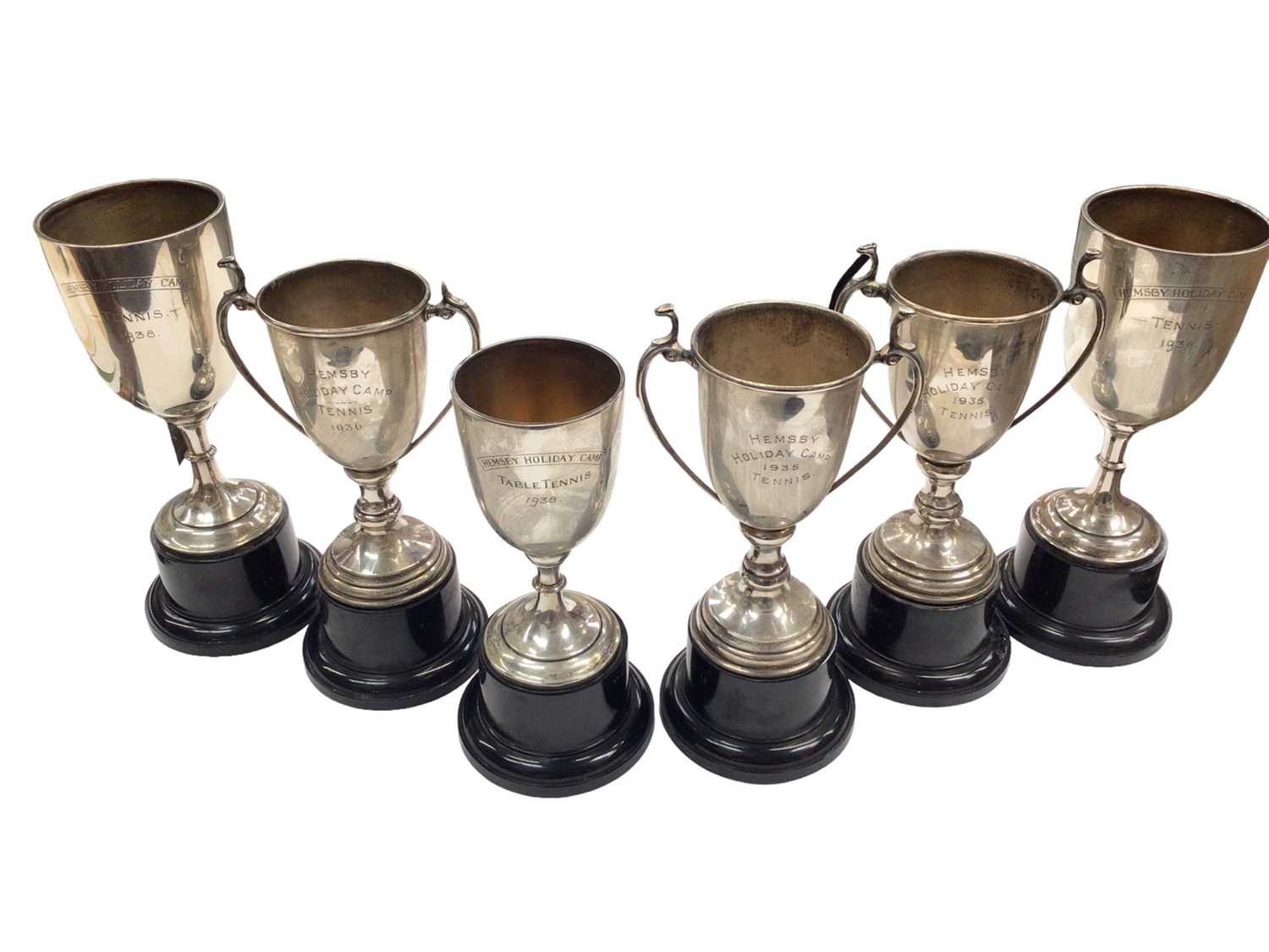 Lot 35 - Six silver tennis related trophies on stands