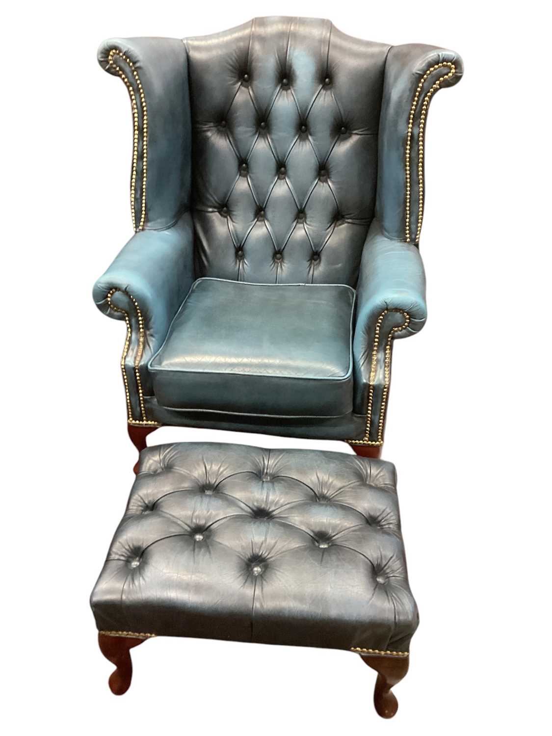 Lot 1201 - Leather wing back chair and footstool