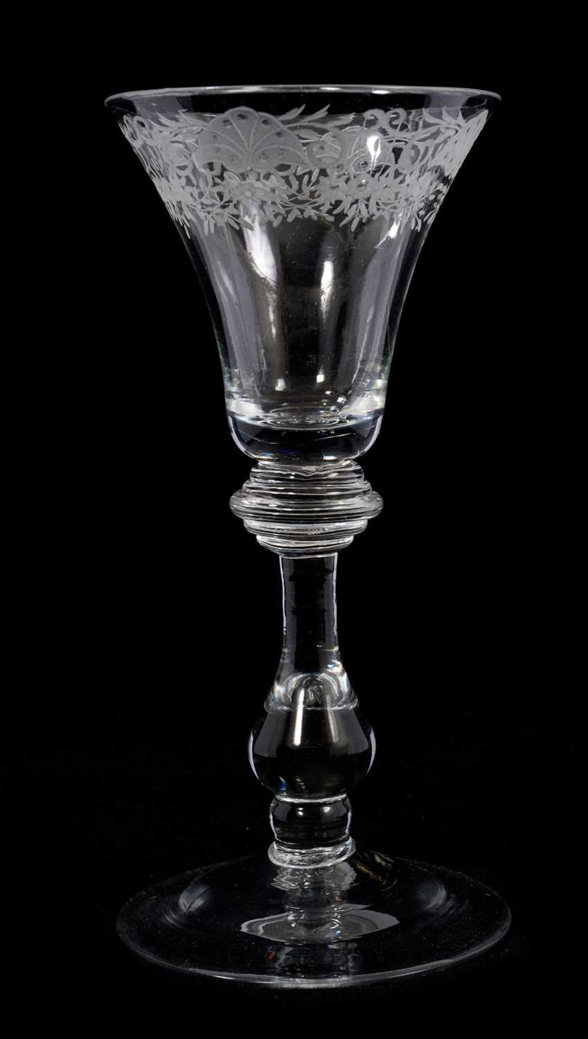 Lot 95 - A baluster wine glass, circa 1725, the bell