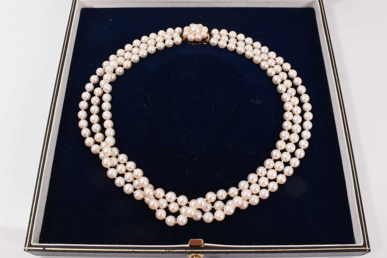 Lot 697 - Cultured pearl three-strand necklace with