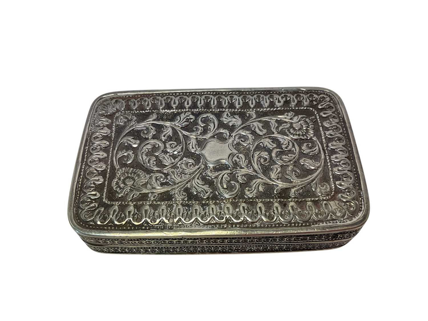 Lot 253 - White metal snuff box with embossed floral