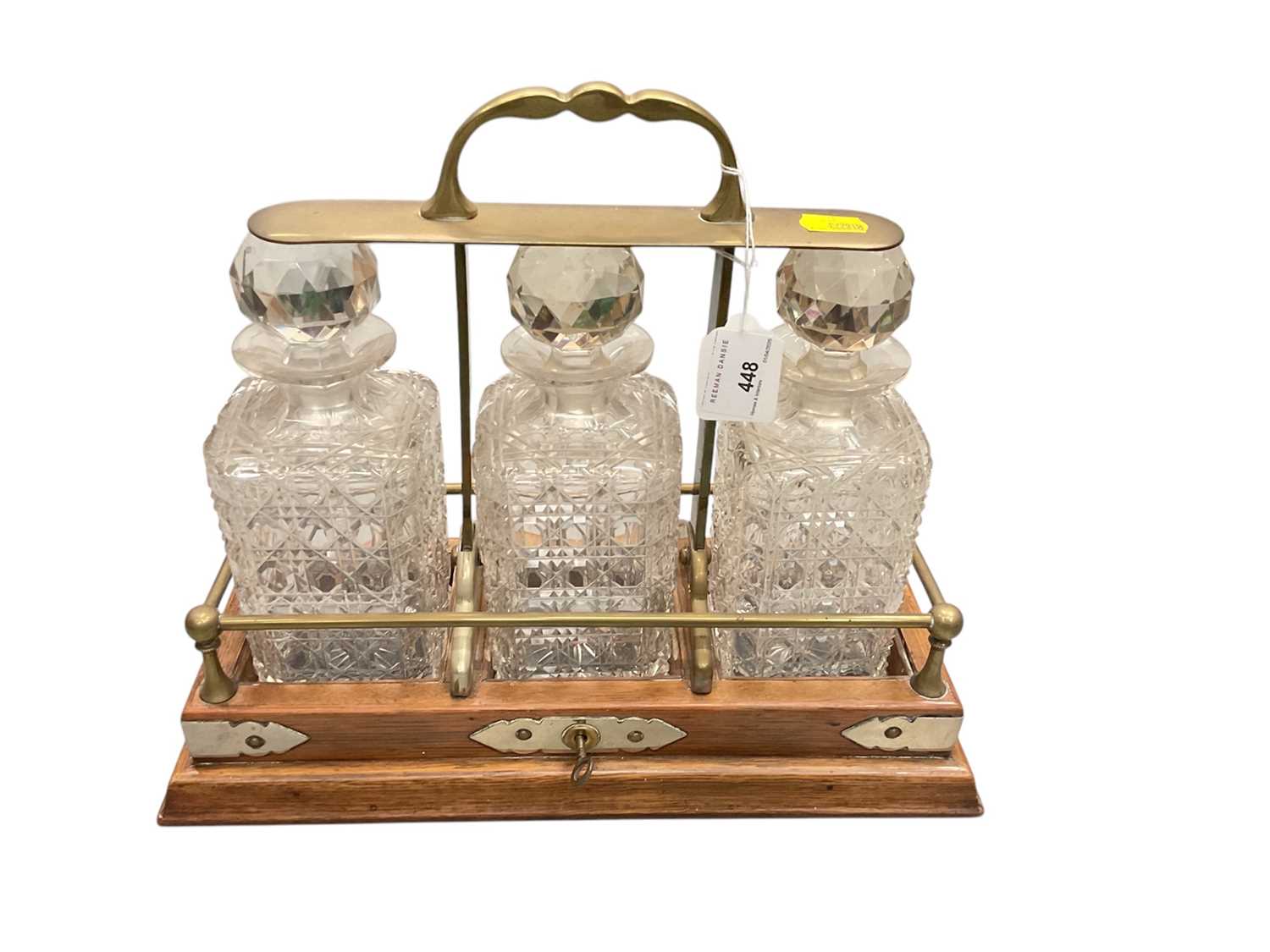 Lot 448 - Edwardian oak three bottle tantalus