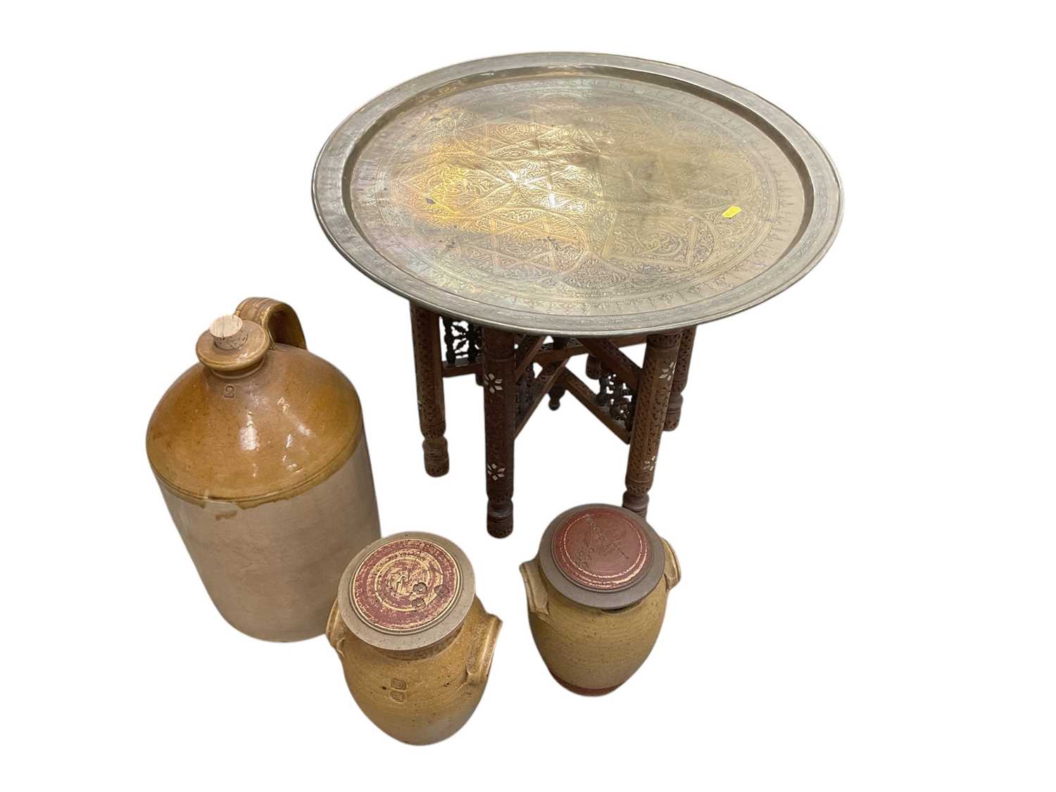 Lot 648 - Indian Benares brass table, stoneware flagon,