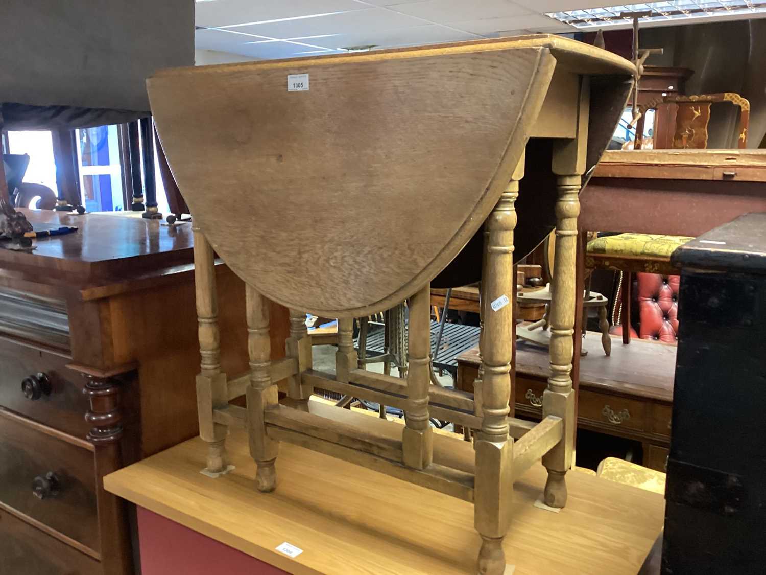 Lot 1305 - Honey oak oval drop flap table on turned