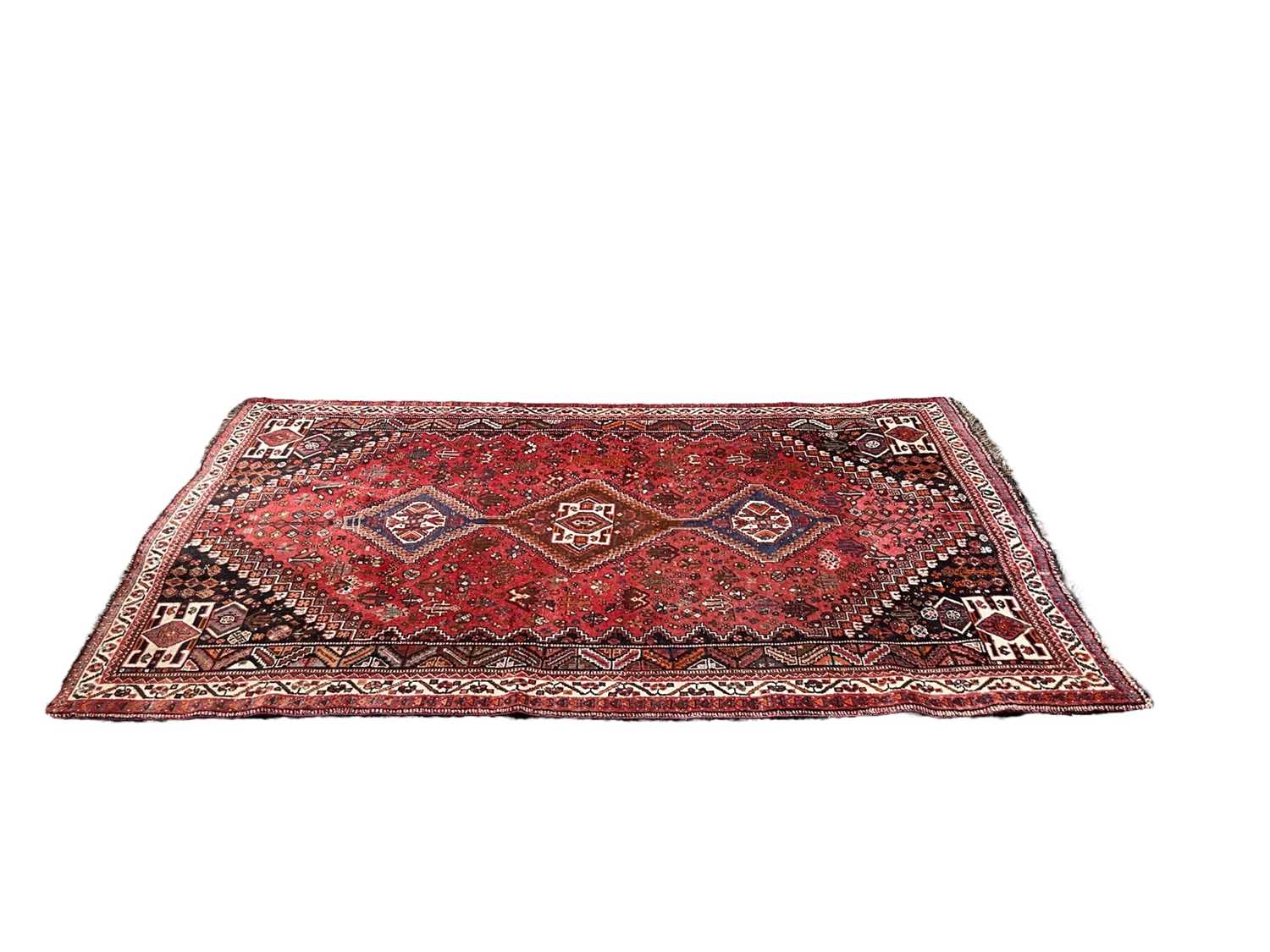 Lot 1335 - Eastern rug with three central medallions