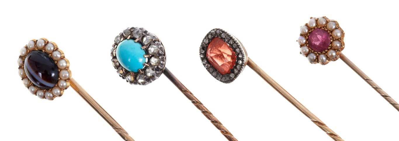 Lot 563 - Four antique stick pins – to include a