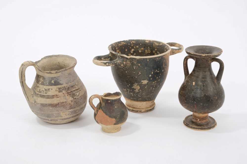 Lot 592 - Etruscan black glazed pottery urn, together
