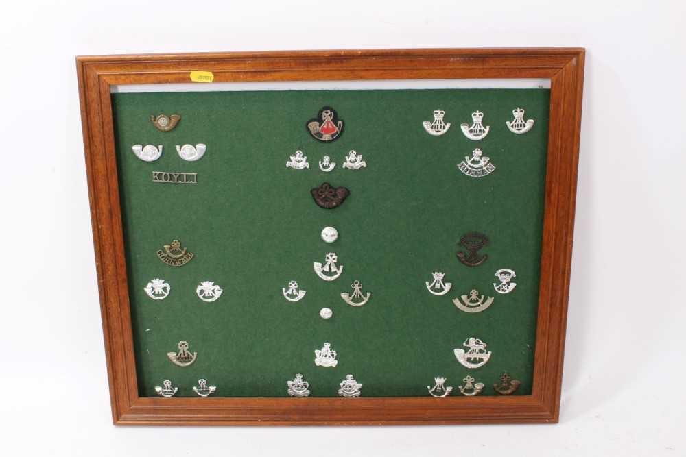 Lot 571 - Eight boards of British military cap badges,