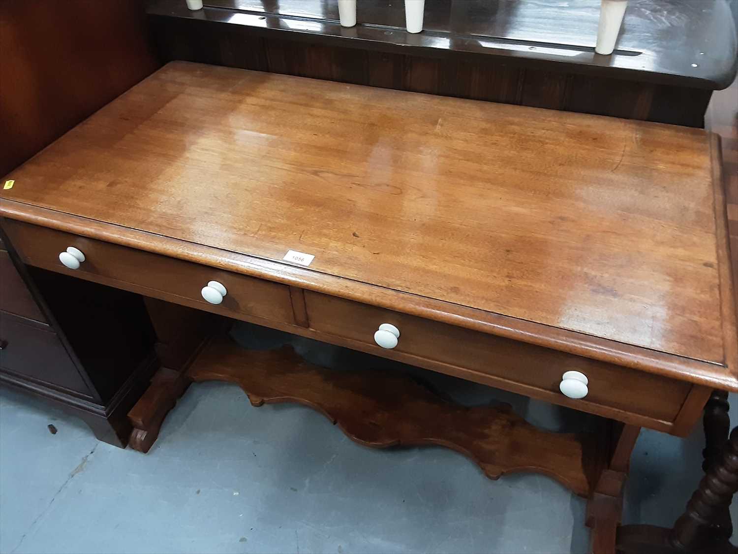 Lot 1056 - Continental mahogany writing table with two