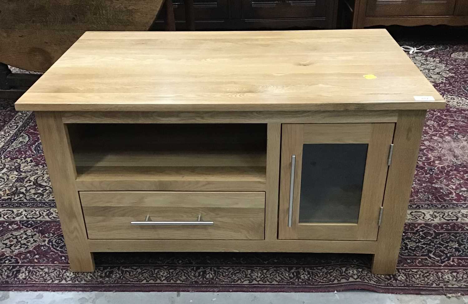 Lot 872 - Light oak TV stand with glazed door, shelf