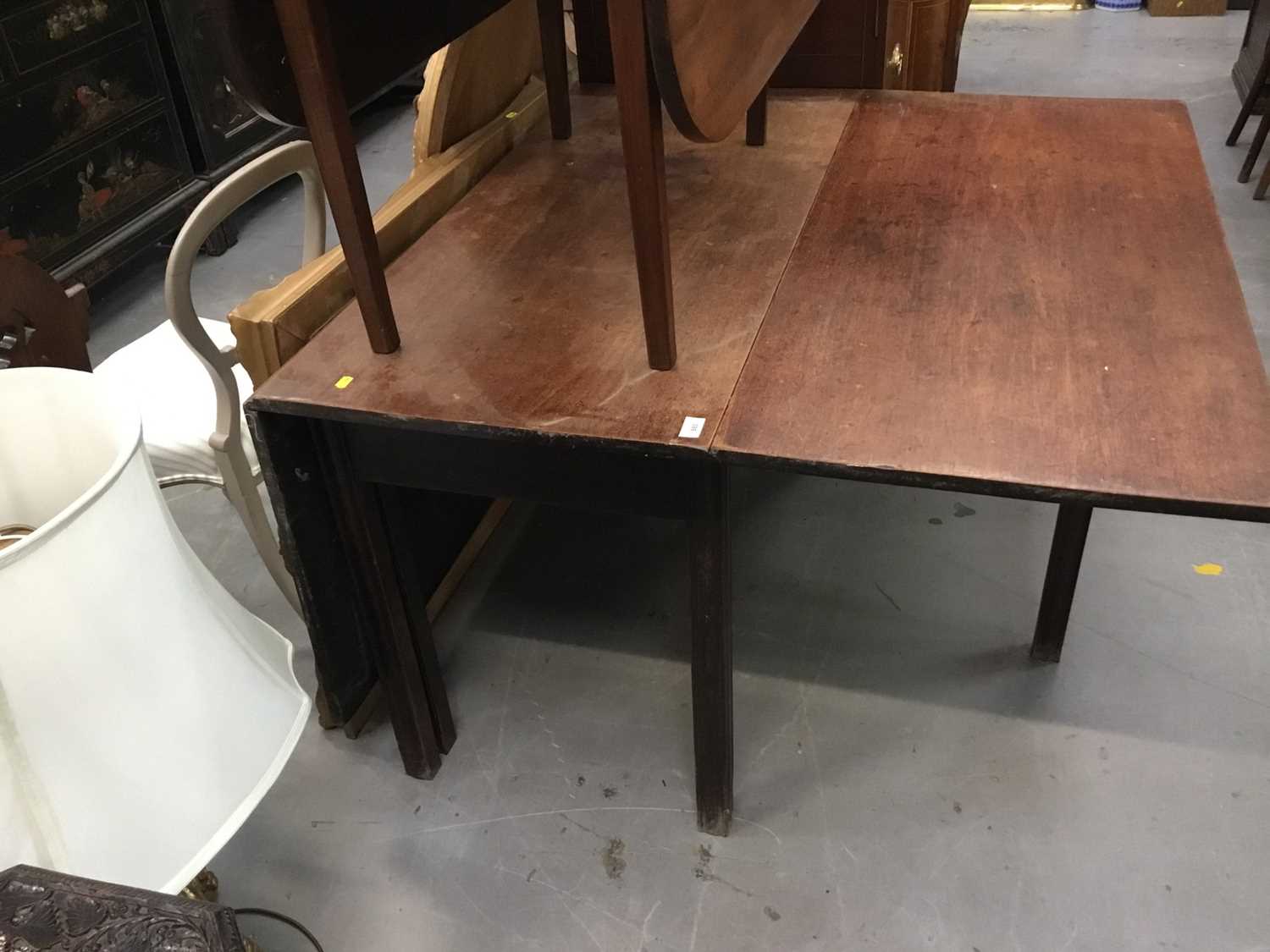 Lot 880 - George III mahogany gateleg dining table on