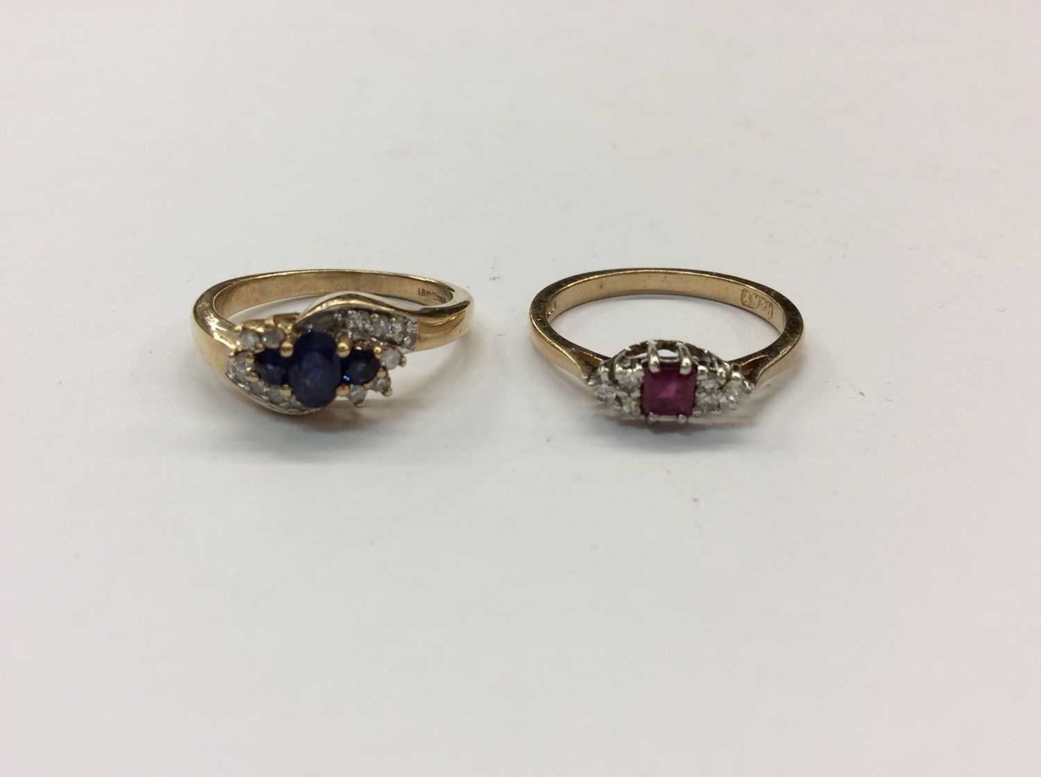 Lot 745 - 9ct gold diamond and sapphire crossover ring