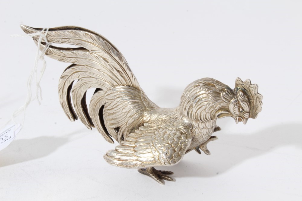 Lot 54 - Pair of silver models of fighting birds,
