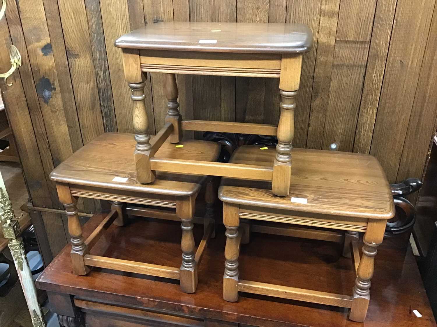Lot 880 - Set of three Ercol elm occasional tables on