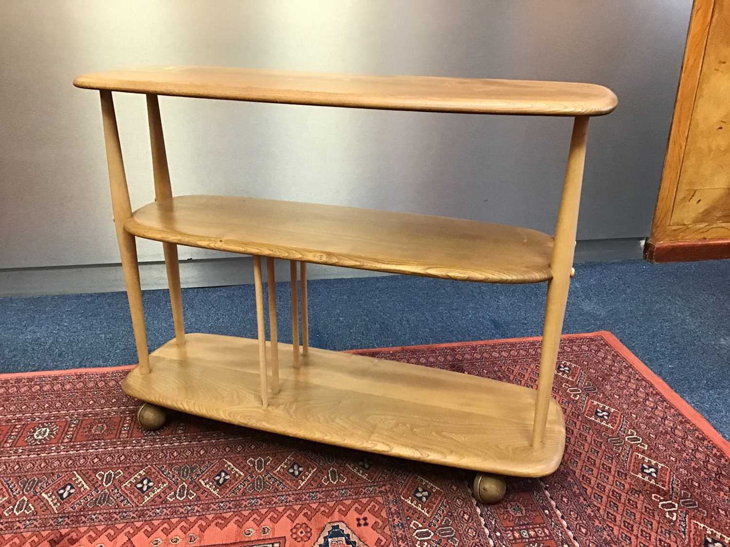 Lot 883 - Ercol elm three tier trolley 90 cm wide, 71
