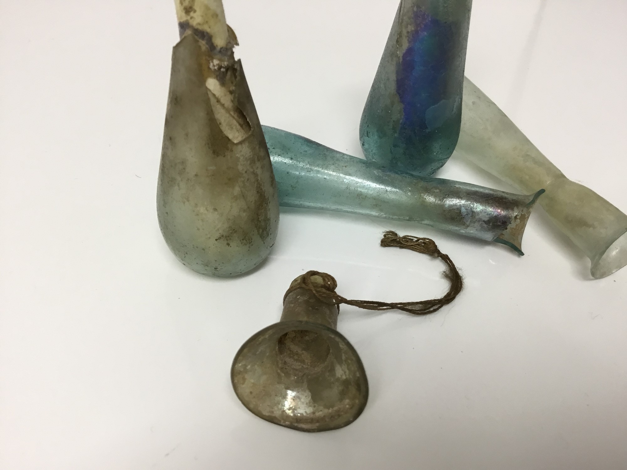 Lot 512 - Four Roman glass tear bottles, including