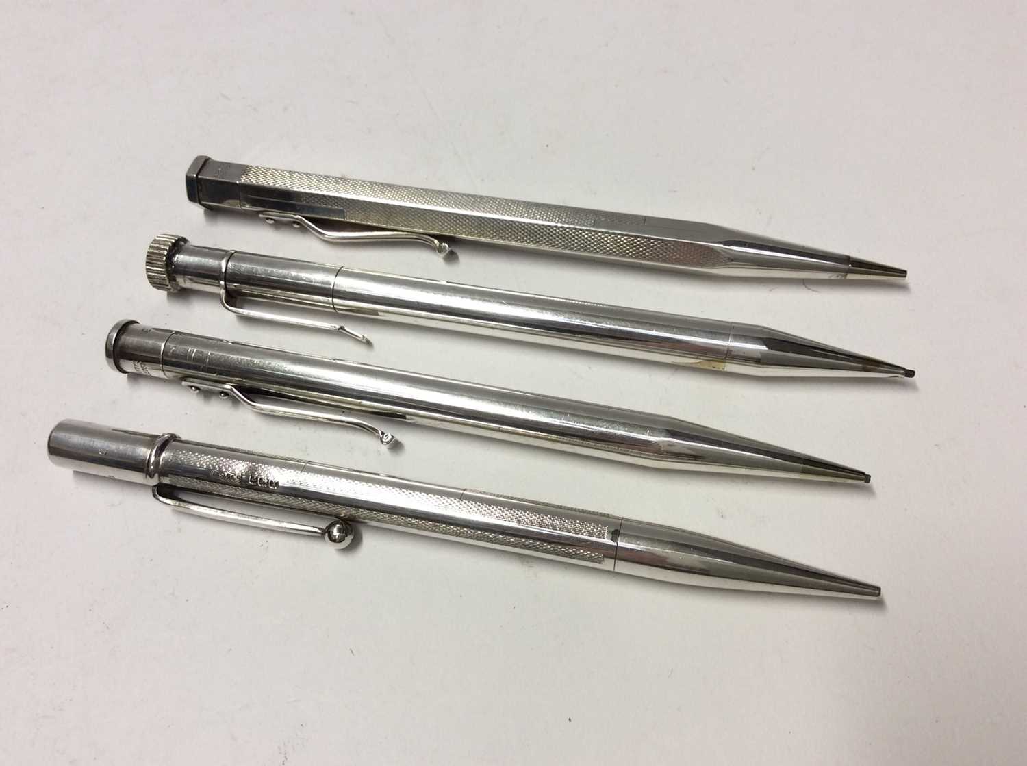 Lot 630 - Two silver propelling pencils and two plated