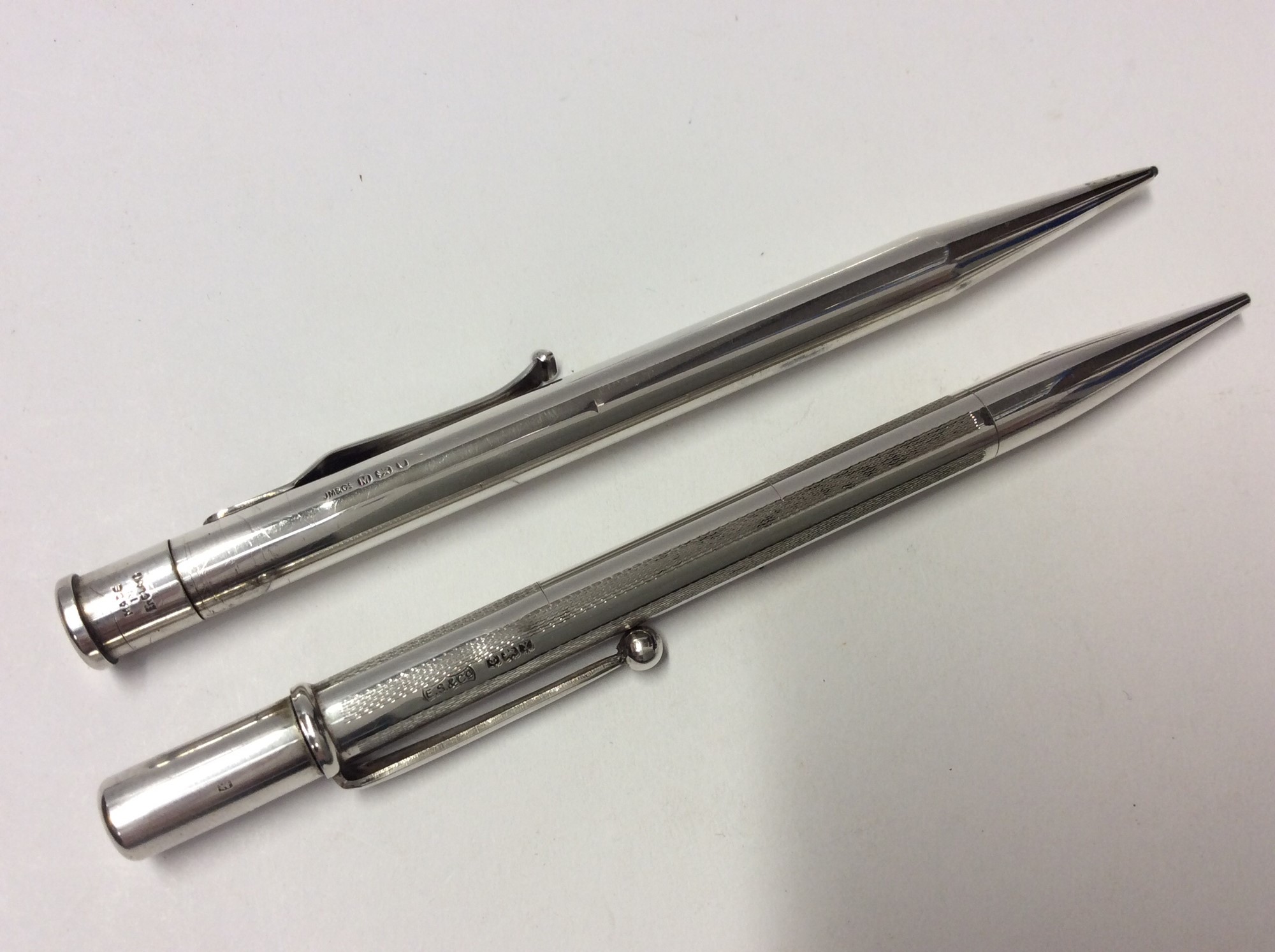 Lot 630 - Two silver propelling pencils and two plated