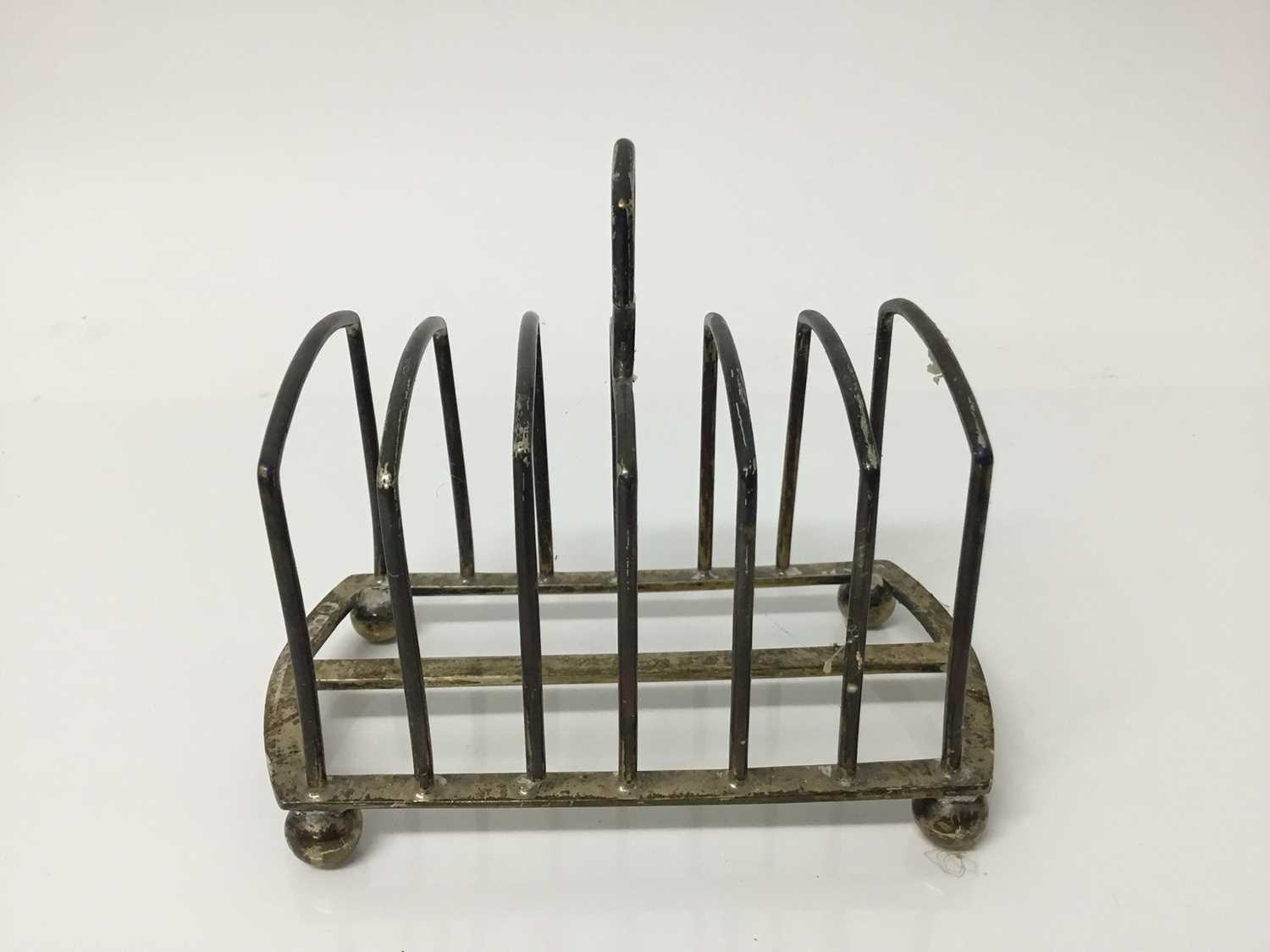 Lot 555 - Two early 20th century silver toast racks,