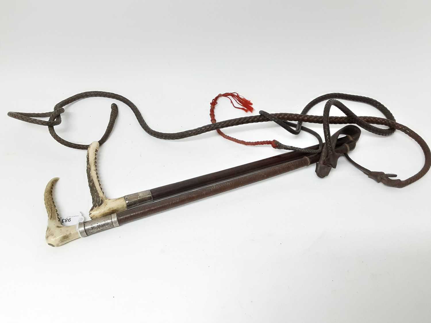 Lot 983 - Two silver mounted hunting whips, both with