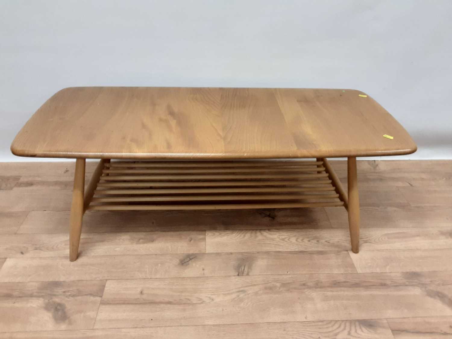 Lot 240 - Ercol elm coffee table with magazine rack