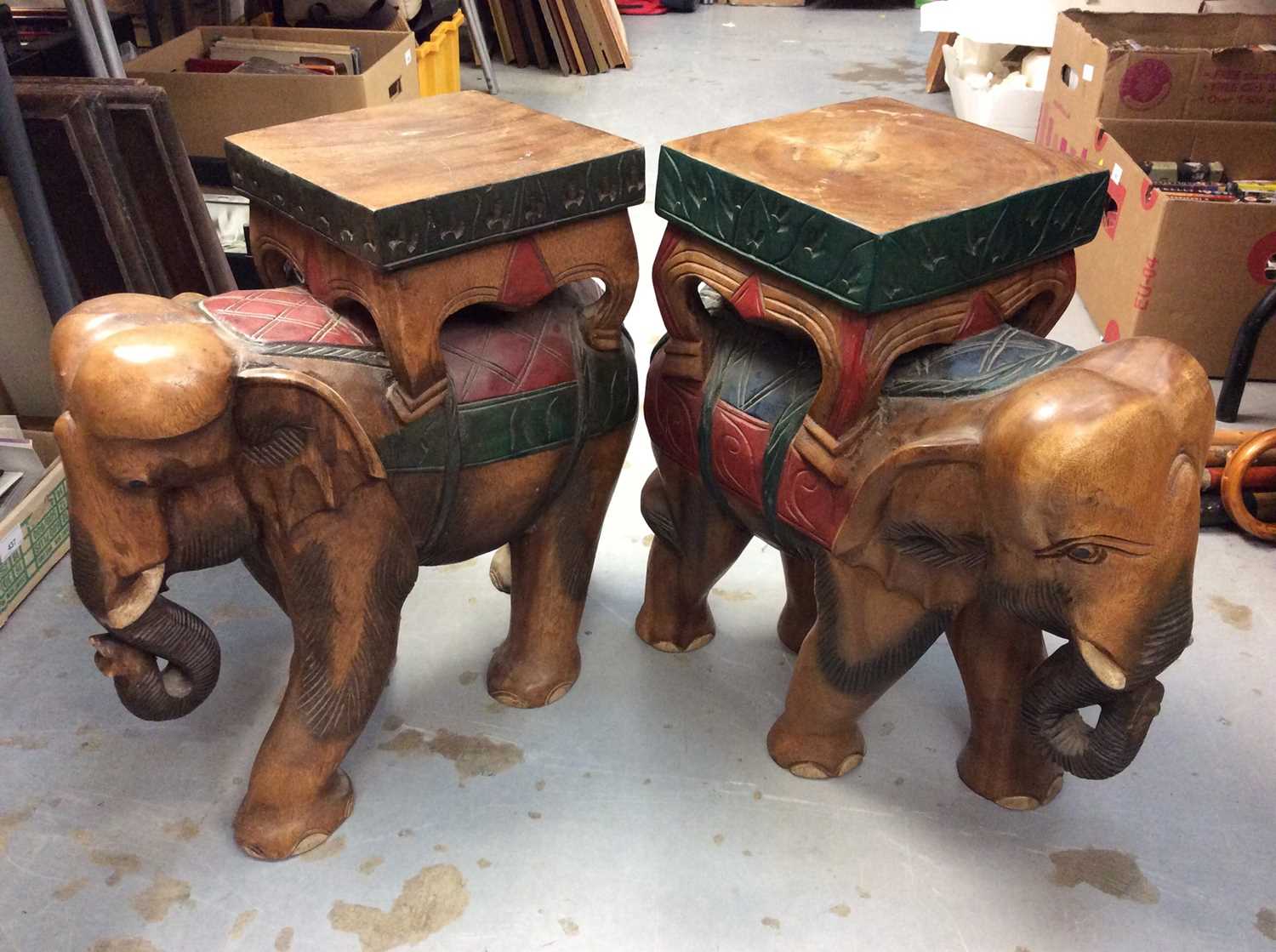 Lot 454 - Two large carved wooden elephant stools, two
