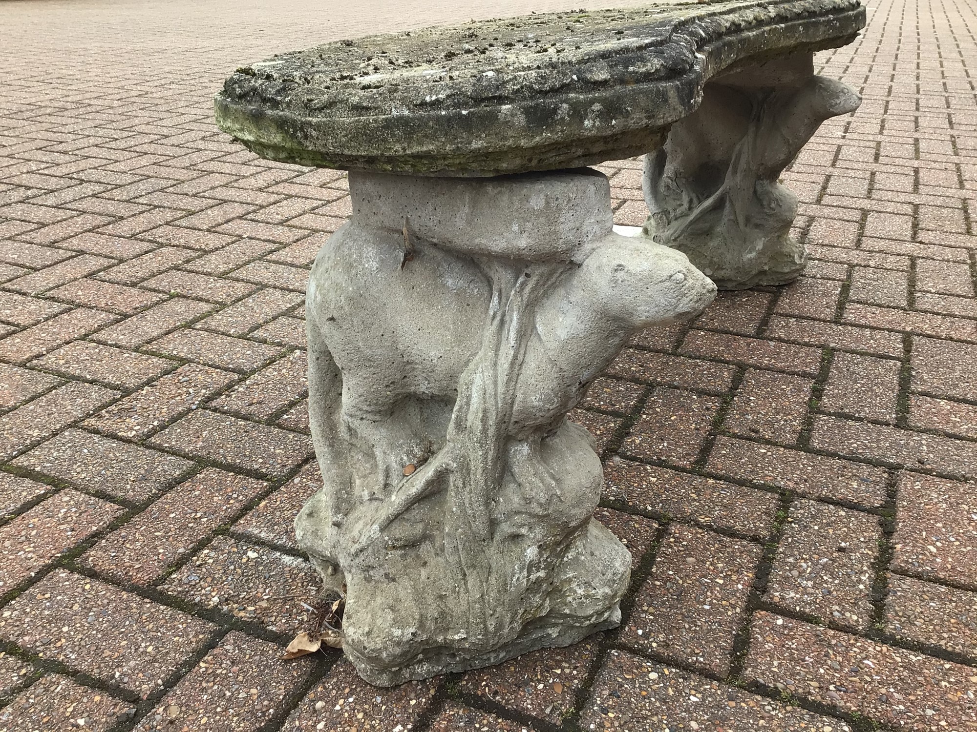 Lot 52 - Concrete garden bench with otter supports