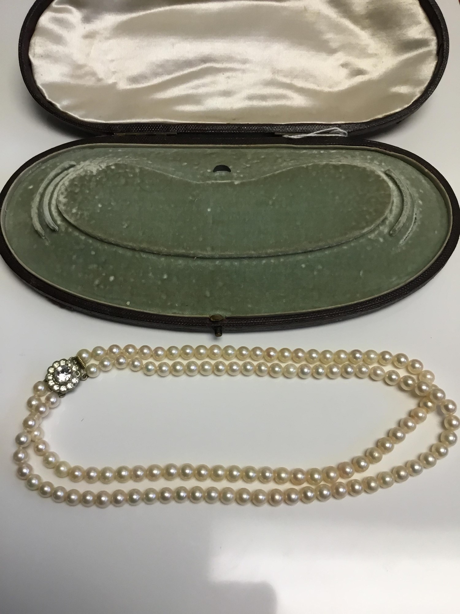 Lot 625 - Cultured pearl two strand necklace in a