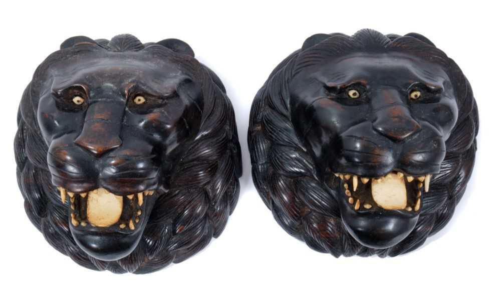 Lot 702 - Pair of Indian carved wooden lion's heads